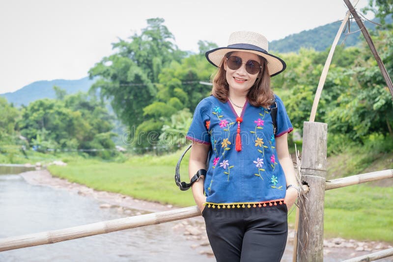 Beautiful Adult Asian Woman Wearing A Straw Hat And Sunglasses Relaxing