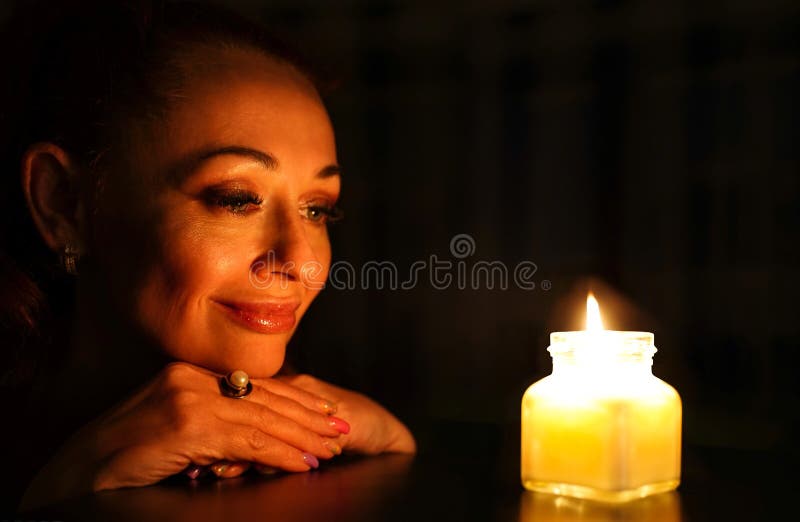 Beautiful Adult Woman Looks At Fire Of Candle Portrait Of A Pensive