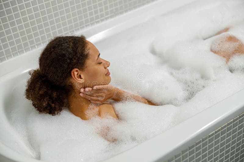 Beautiful Afro American Woman Takes Bubble Bath In Bathtub Spa