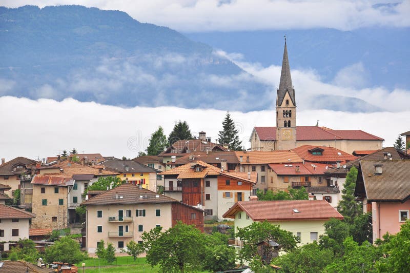 Beautiful Alpine Village with Clouds on Ground Stock Image - Image of ...