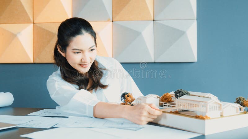 Beautiful Architect Measuring House Model while Taking a Note ...