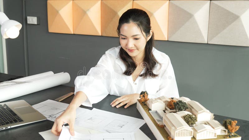 Beautiful Architect Measuring House Model while Taking a Note ...