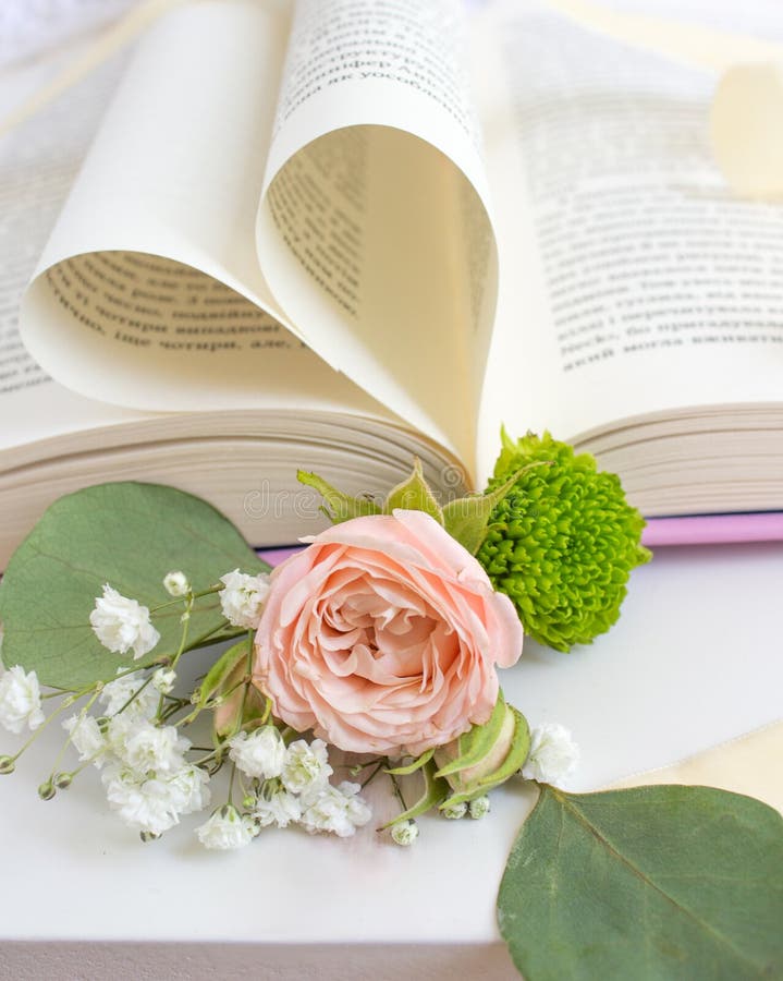 A Beautiful Arrangement of a Bouquet of Roses and a Book Stock Image ...