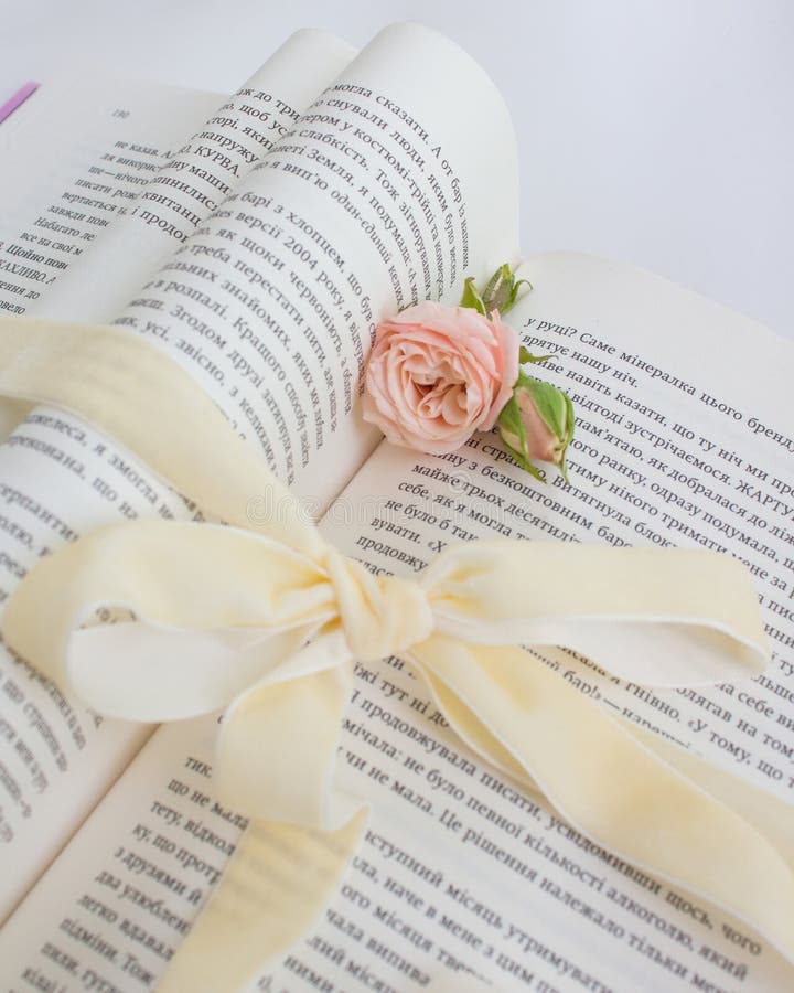 A Beautiful Arrangement of a Bouquet of Roses and a Book Stock Photo ...