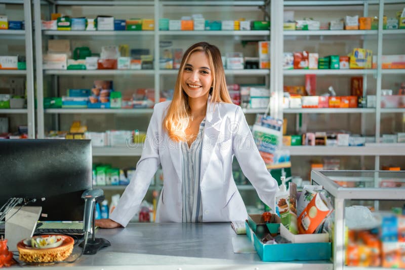 Beautiful Asian Female Pharmacist in Uniform Smiling at the Camera ...