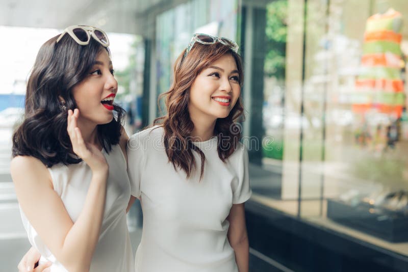 Beautiful Asian Girls With Shopping Bags Walking On Street Stock Image