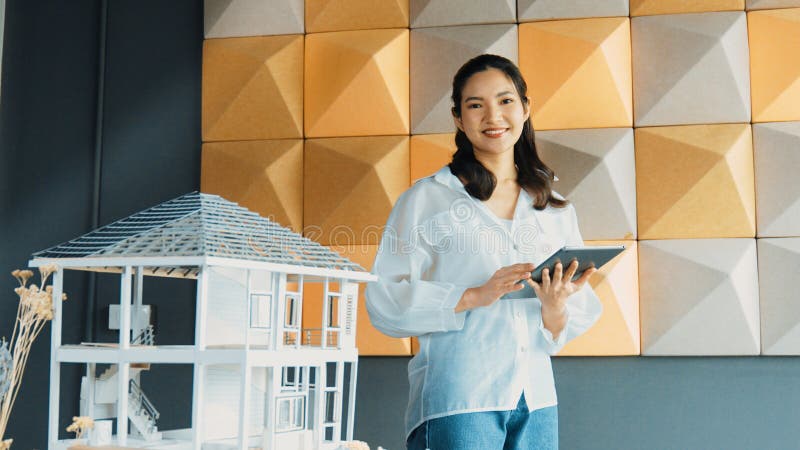 Beautiful Asian Project Manager Using Tablet Check House Model ...