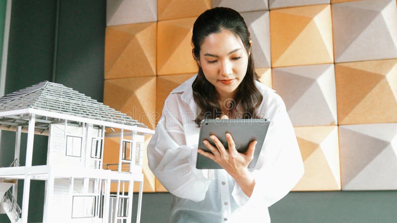 Beautiful Asian Project Manager Using Tablet Check House Model ...