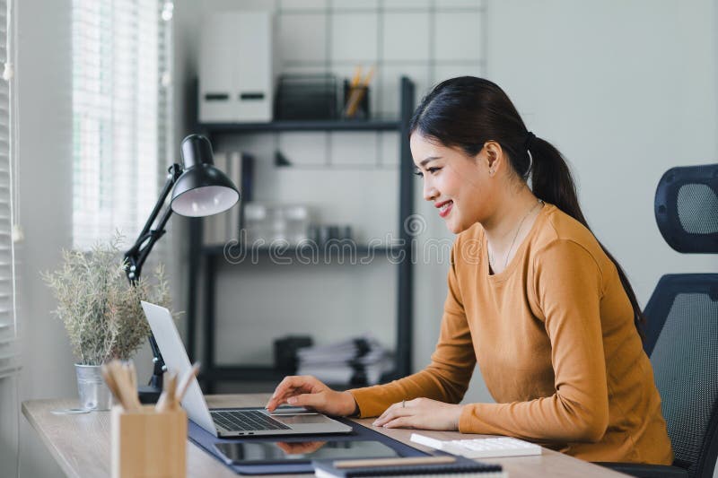 Beautiful Asian Small Business Owner Using Laptop while Working at Home ...