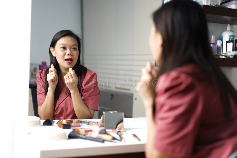 Beautiful Asian Woman Doing Makeup and Applying Lipstick Stock Image ...