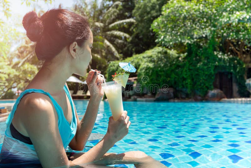Beautiful Asian Woman Having Cocktail In Swimming Pool On Vacation