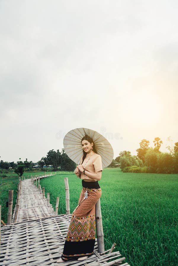 Beautiful Asian Woman in Local Dress Holding Paper Umbrella Standing ... Beautiful Asian Woman in Local Dress Holding Paper Umbrella Standing ...
