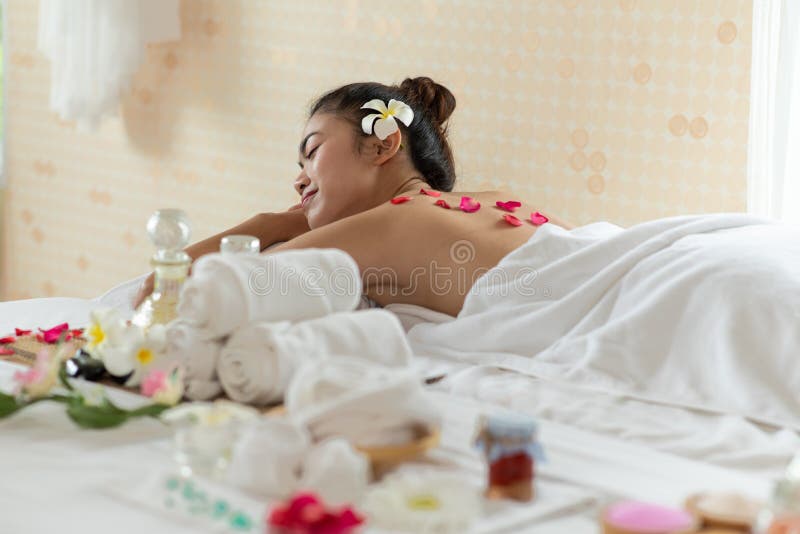 Beautiful Asian Woman Lying Down On Massage Bed Relaxing In Spa Salon
