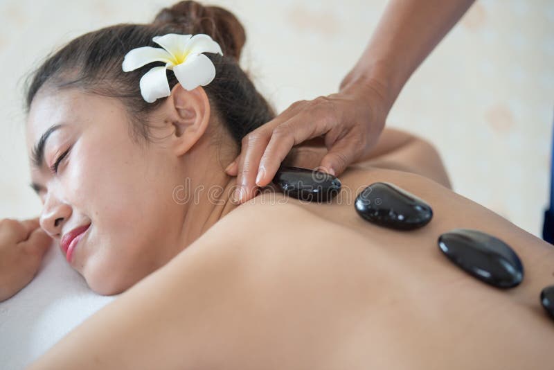 Beautiful Asian Woman Lying Down On Massage Bed With Traditional Hot