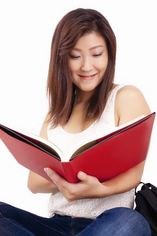 Beautiful Asian Young Woman with Backpack Reading Red Book Stock Photo ...