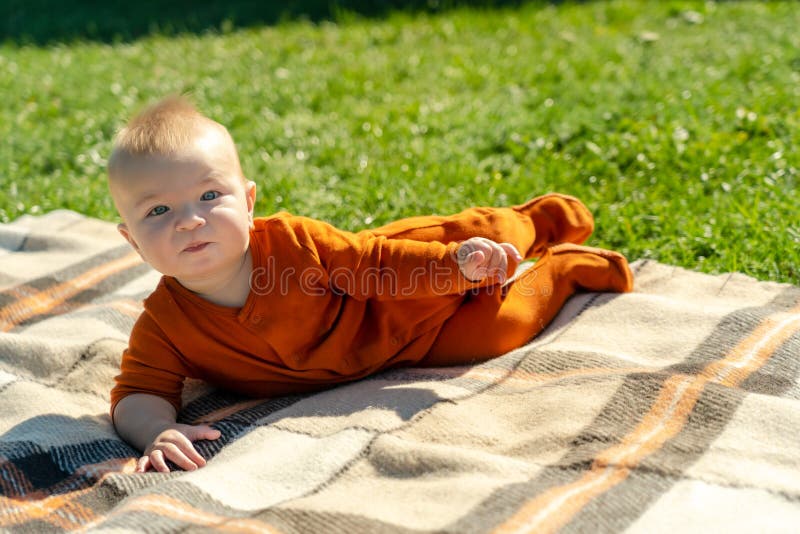 Beautiful Baby Lying on the Plaid on Sunny Grass Stock Photo - Image of ...