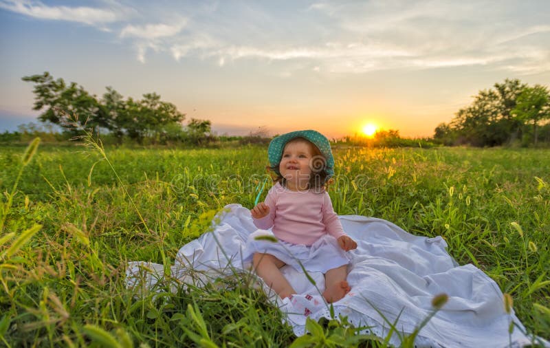 Beautiful Baby Sitting on Blanket at Sunset Stock Photo - Image of blue ...