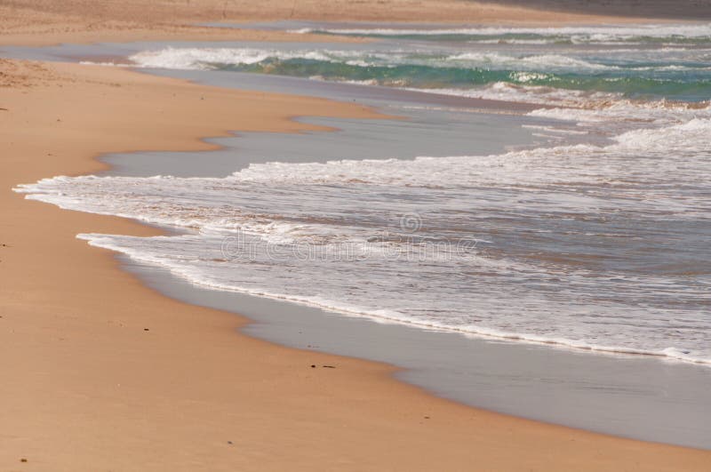 Beautiful Beach with Mild Waves and Cityscape on the Background Stock ...