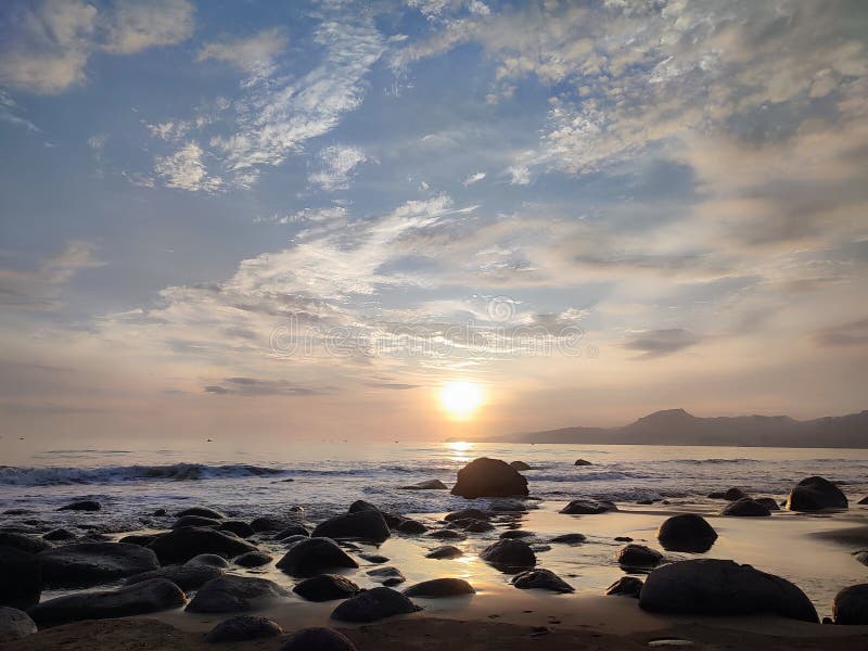 The Beautiful Beach with Bright Clouds and Solid Rocks is Simply ...