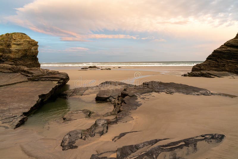 Beautiful Beach with Fine Sand and Rocky Cliffs at Sunrise Stock Image ...
