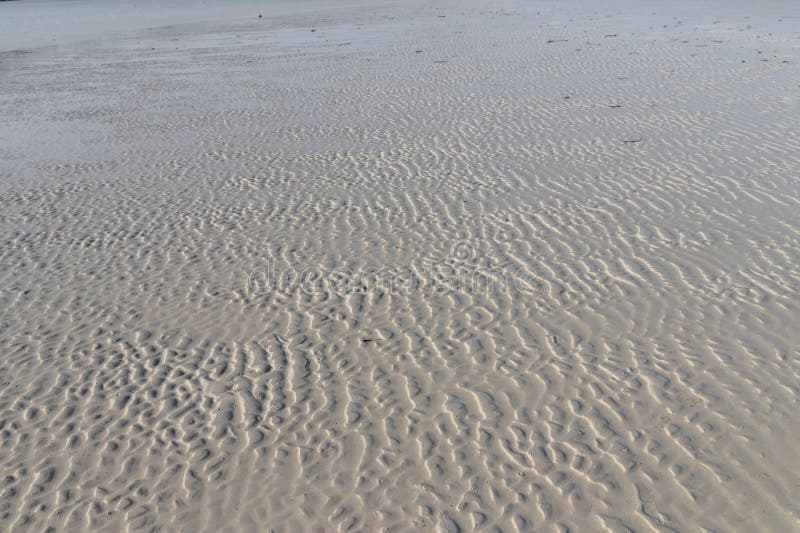 A Beautiful Beach with White Sand and Clear Water. the Sand is Rippled ...