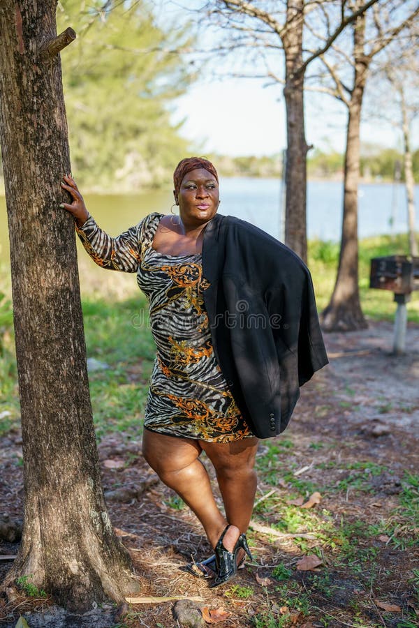Beautiful Black Plus Sized Model Posing by a Tree in a Tranquil Park ...