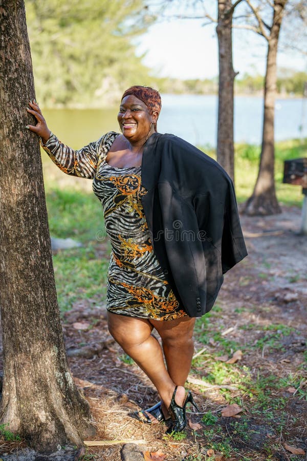 Beautiful Black Plus Sized Model Posing by a Tree in a Tranquil Park ...