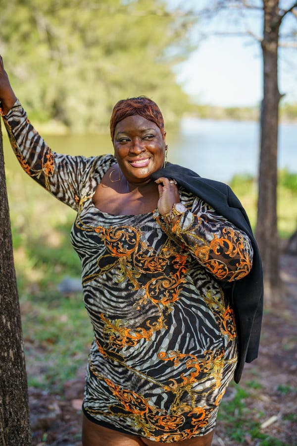 Beautiful Black Plus Sized Model Posing by a Tree in a Tranquil Park ...