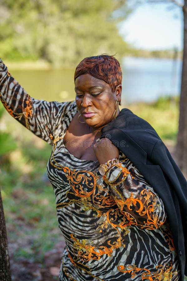 Beautiful Black Plus Sized Model Posing by a Tree in a Tranquil Park ...