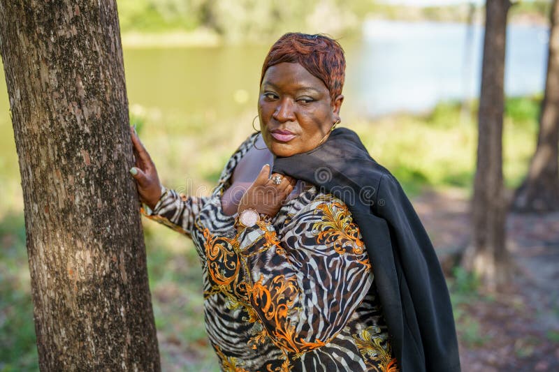 Beautiful Black Plus Sized Model Posing by a Tree in a Tranquil Park ...