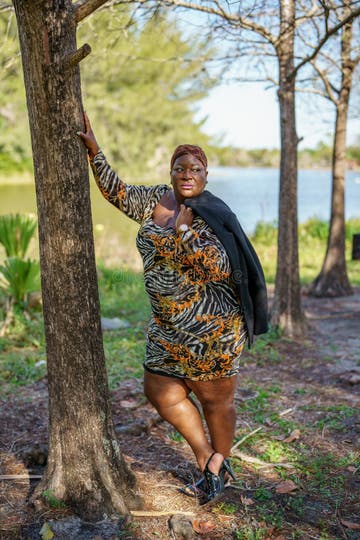 Beautiful Black Plus Sized Model Posing by a Tree in a Tranquil Park ...