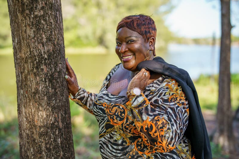 Beautiful Black Plus Sized Model Posing by a Tree in a Tranquil Park ...