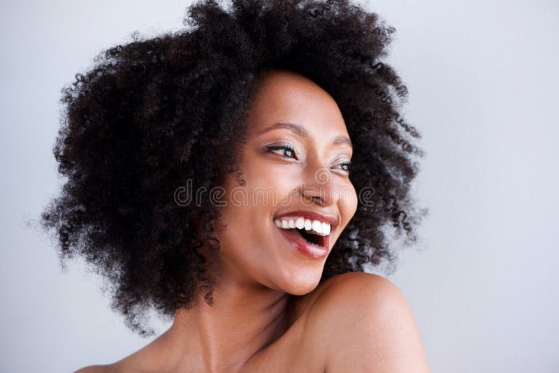 Beautiful Black Woman With Curly Hair Laughing And Looking Away Stock