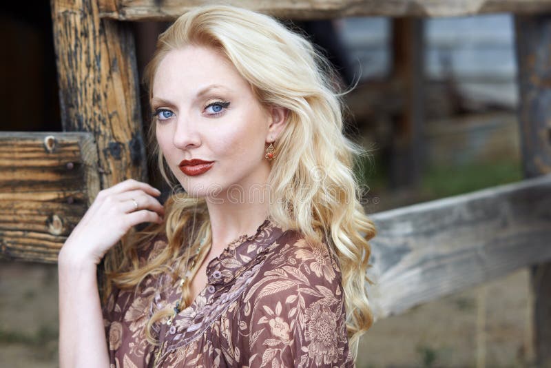 Beautiful Blonde Against Rustic Fence Stock Photo - Image of posing ...