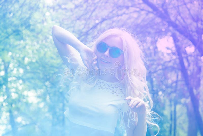 Beautiful Blonde Girl Dancing In A Multi Colored Smoke Outdoors In The