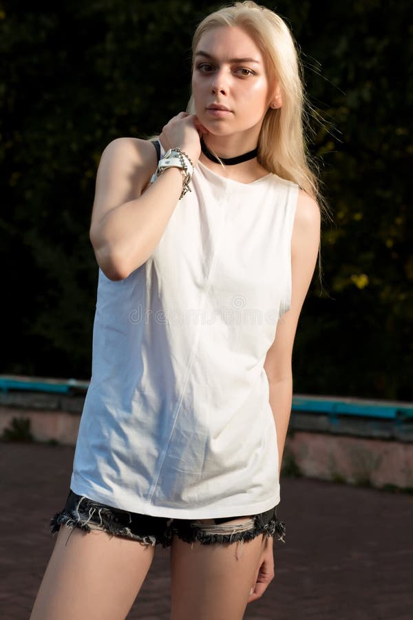 Beautiful Blonde Girl With Long Hair Dressed In Fashionable Clot Stock