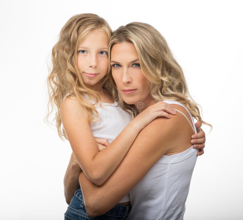 Beautiful Blonde Smiling Mother And Daughter Lay On Bed Together On