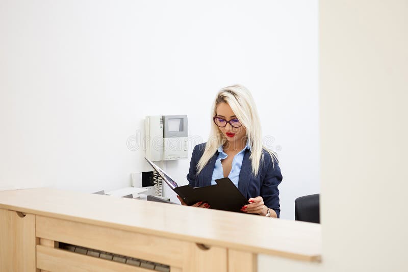Beautiful Blonde Secretary Looking at Folder with Documents Stock Image ...