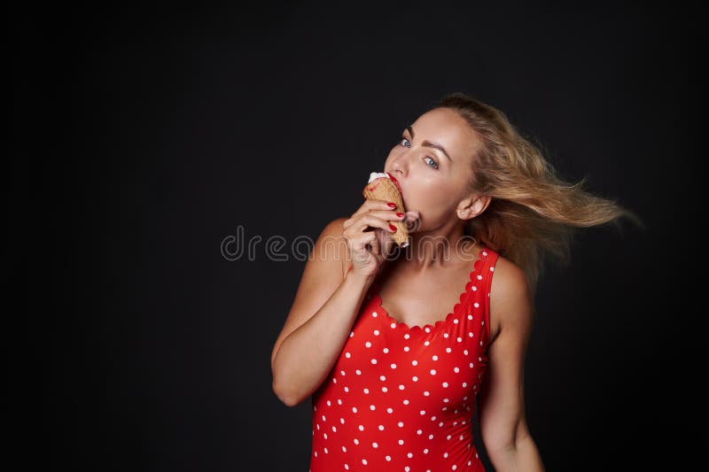 Beautiful Blonde Woman With Flying Hair From The Wind Wearing A Red