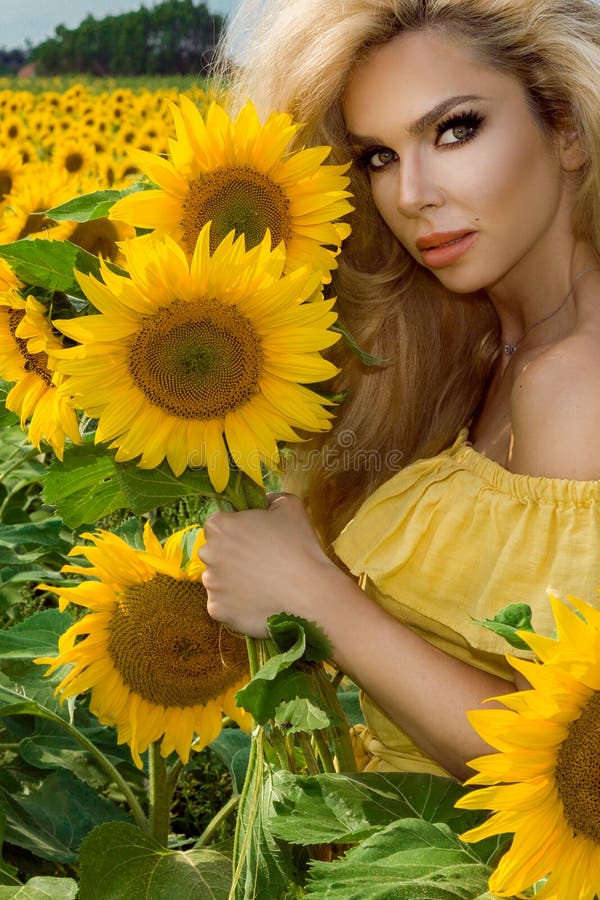 Beautiful Blonde Woman Standing on a Meadow with Sunflowers Stock Photo ... Beautiful Blonde Woman Standing on a Meadow with Sunflowers Stock Photo ...