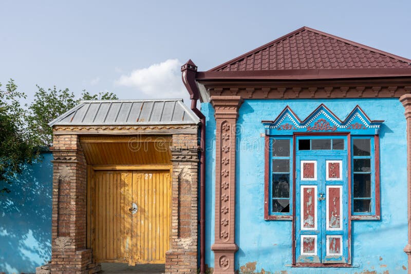 Beautiful Blue Old House Building with Wooden Doors and Engravings on ...