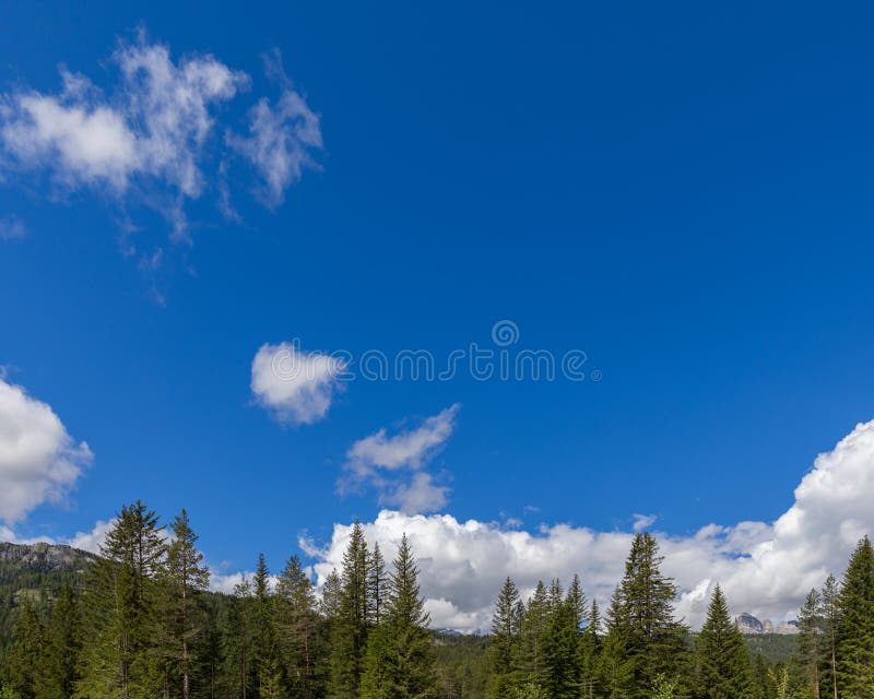 Beautiful Blue Sky with Textured Clouds and Mountain Peaks Along the ...