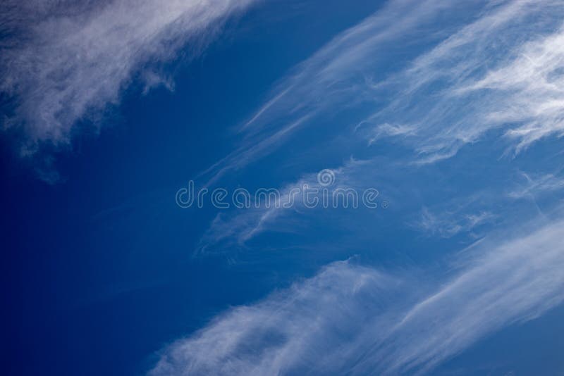 Blue Sky With White Wispy Clouds In The Background Stock Image - Image ...
