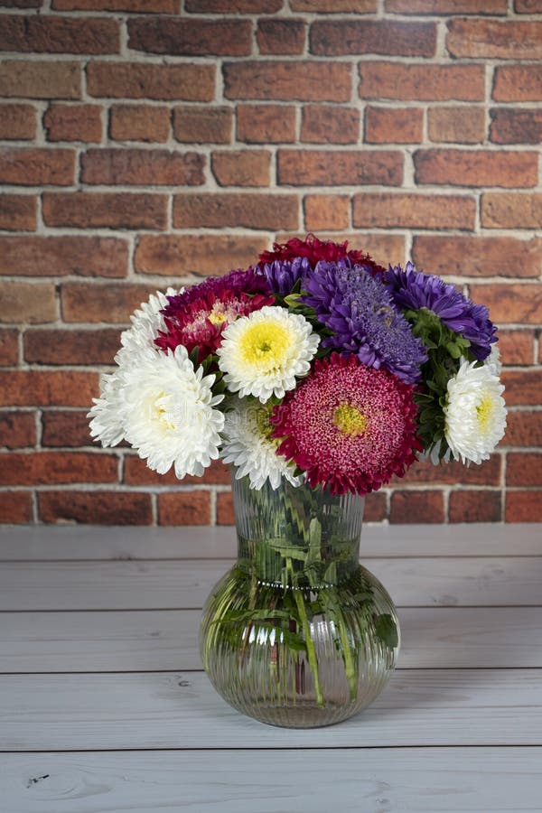 Beautiful Bouquet of Asters on White Wooden Table in Front of Brick ...