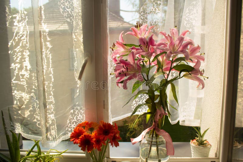 A Beautiful Bouquet of Flowers on the Window. Lilies on the Window ...