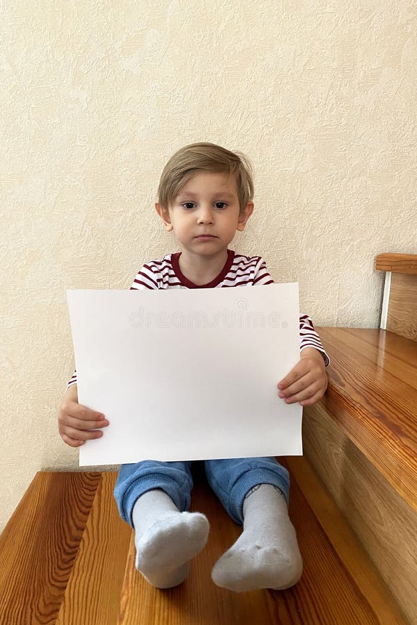 A Beautiful Boy is Holding a Clean White Sheet of Paper Stock Photo ...
