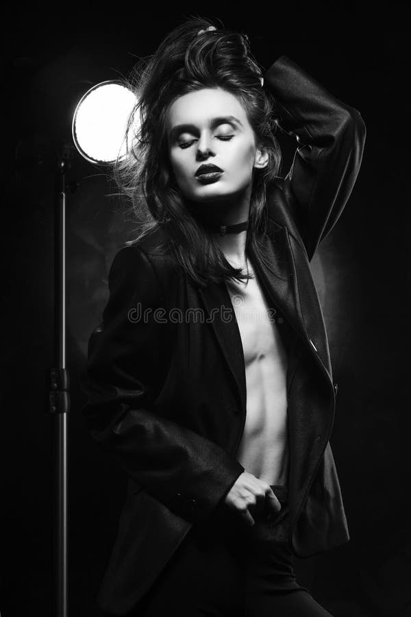 Beautiful Braless Slim Girl Wearing A Unbuttoned Black Blazer With A