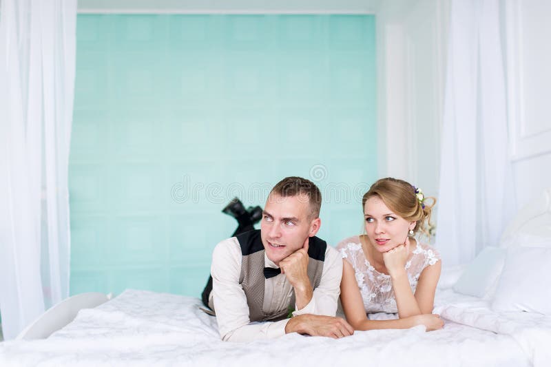 The Beautiful Bride and Groom on Bed Wedding Stock Photo - Image of ...