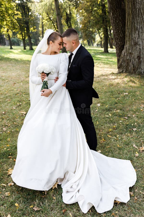 Beautiful Bride and Groom Walking in the Park. Wedding Day Stock Photo ...