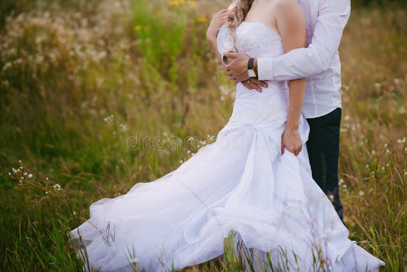 Beautiful Bride Hugs Groom On Nature In The Sunset Light Wedding